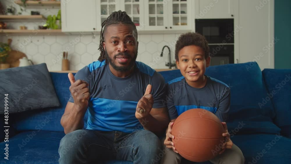 Fully in engrossed in game handsome African American father and joyful ...