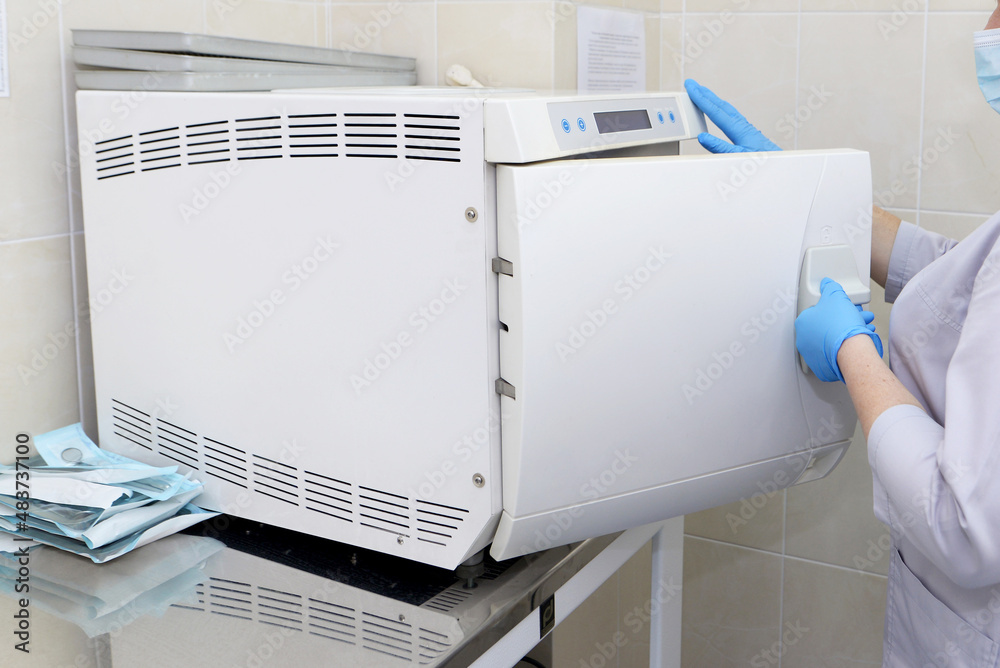 Sterilization of medical instruments in an autoclave. Dental office. A ...