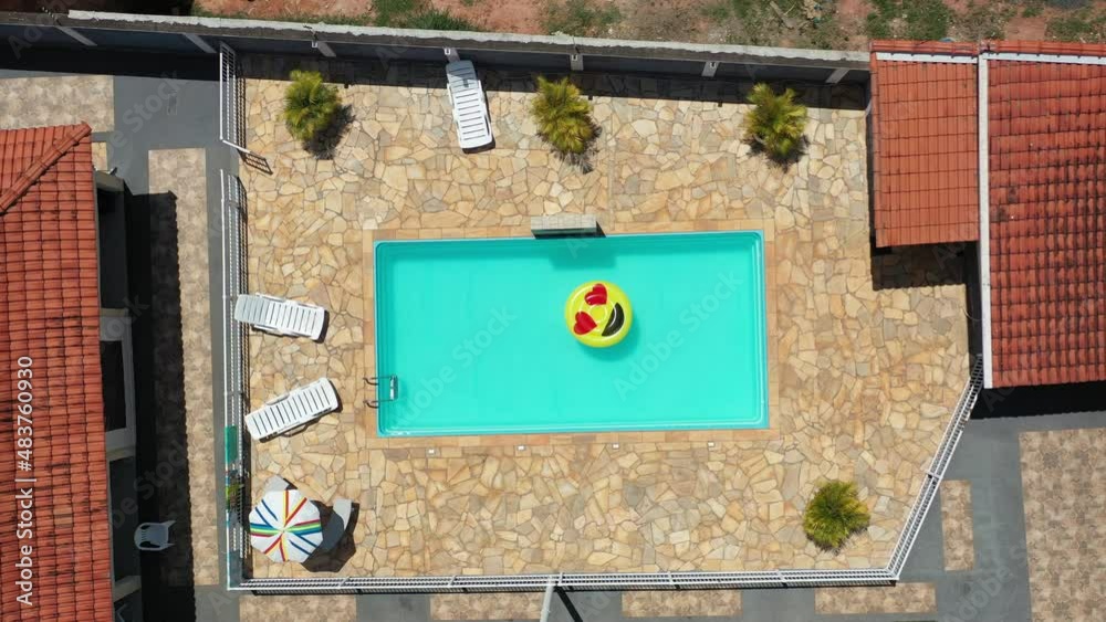 Aerial view of smile emoji float at swimming pool. Float smile emoji ...