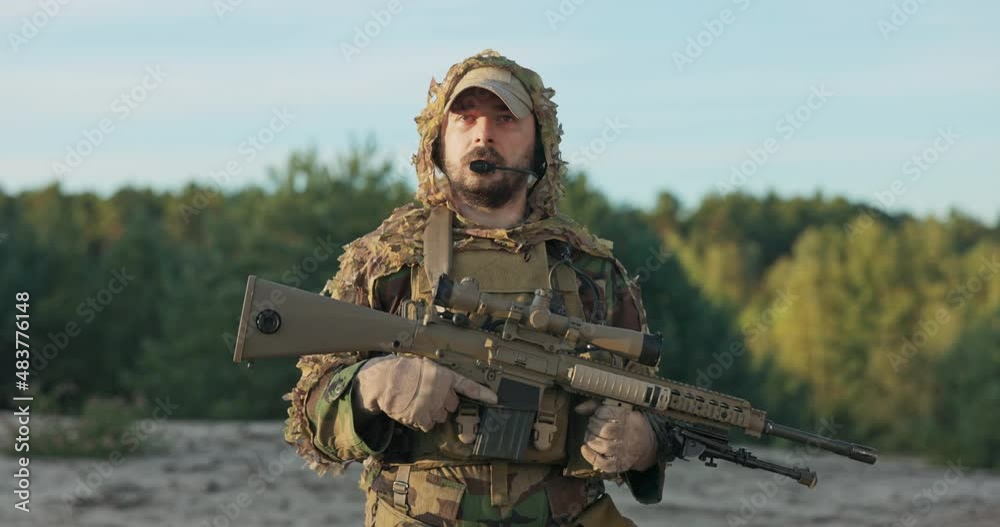 Portrait of soldier with serious face wearing moro uniform, helmet and ...