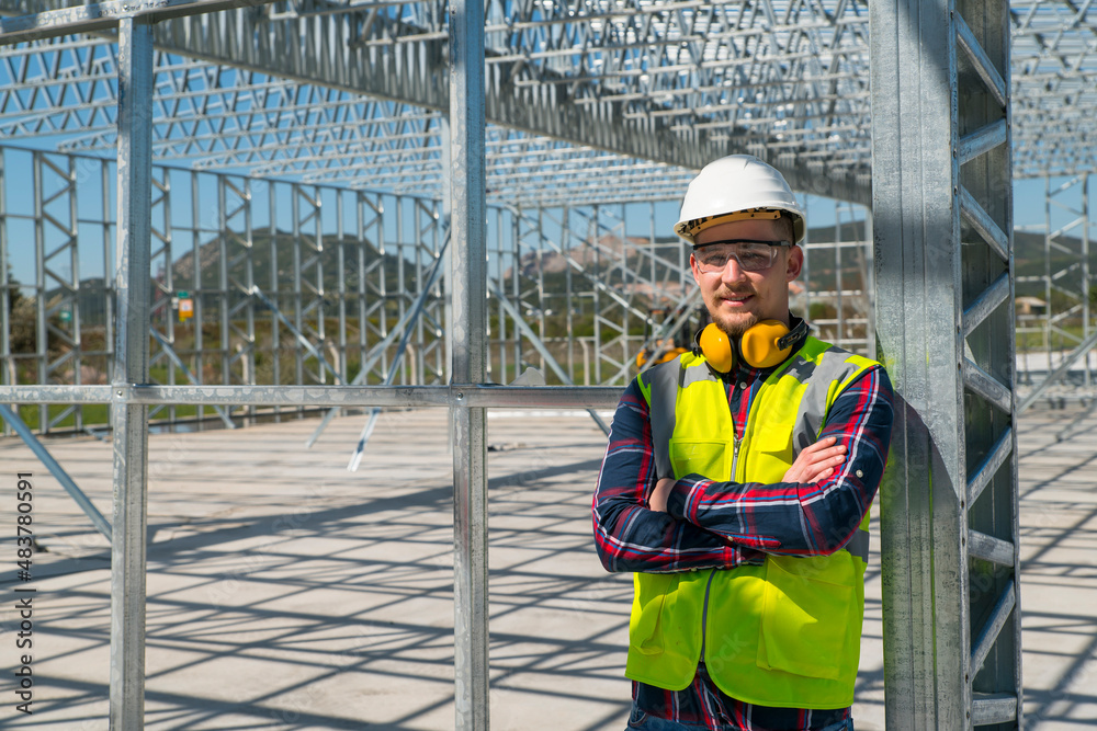 Cheerful construction worker smiling at the camera while sitting ...