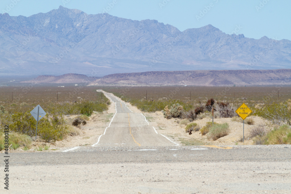 heat distortion rises over an intersection of single lane road to the ...