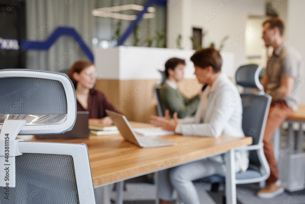 Close up background image of office space with blurred people in back ...