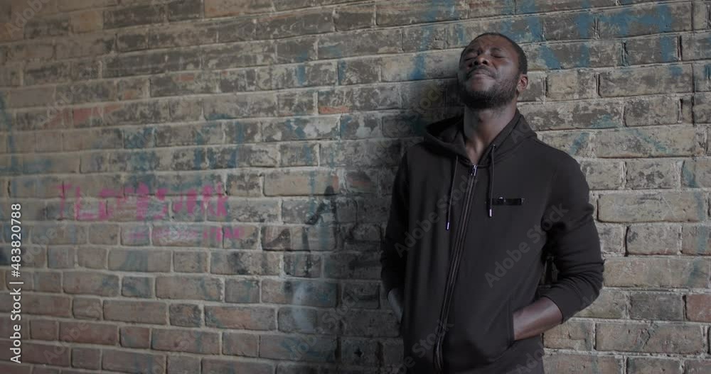 Black Drug addict man taking drugs on street. Man in black wear using ...