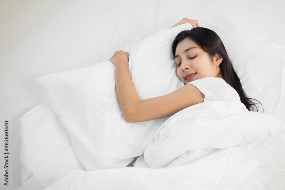 Beautiful asian woman lying in the bed . Young woman sleeping well in ...