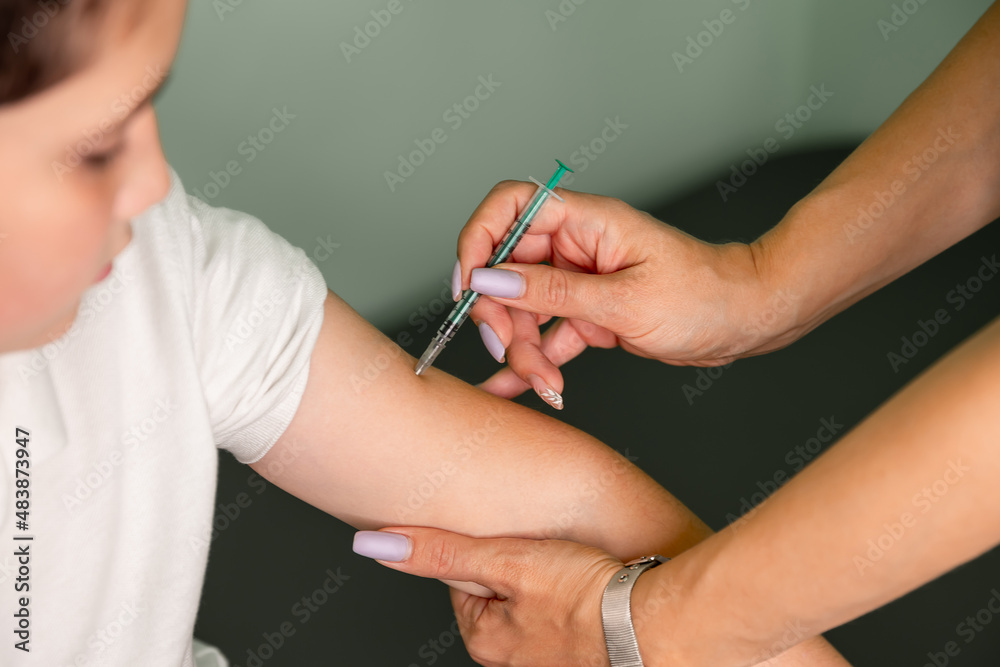 Nurse with syringe vaccinating teenager with anti-virus vaccine ...