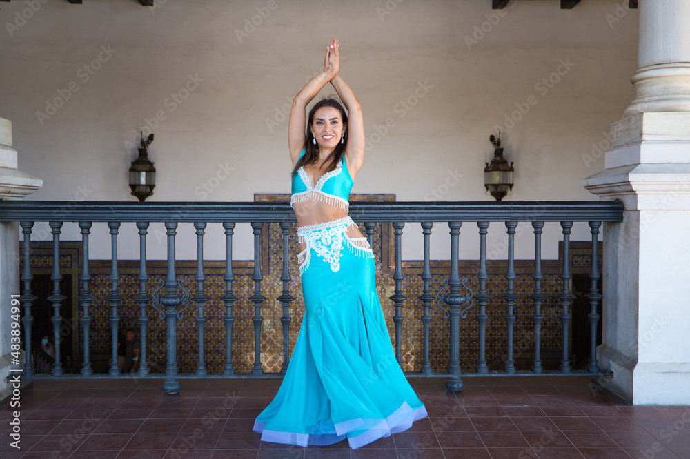 beautiful young belly dancer is posing for the camera in a photo shoot ...