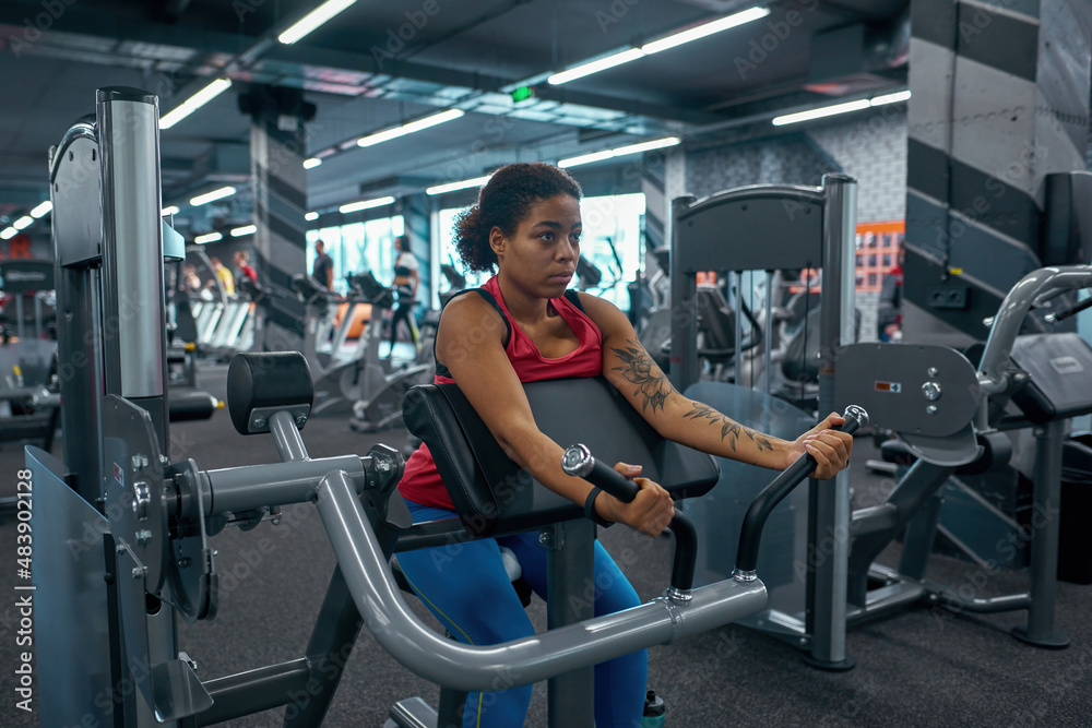 Black girl doing sport exercise for biceps in gym Stock Photo | Adobe Stock