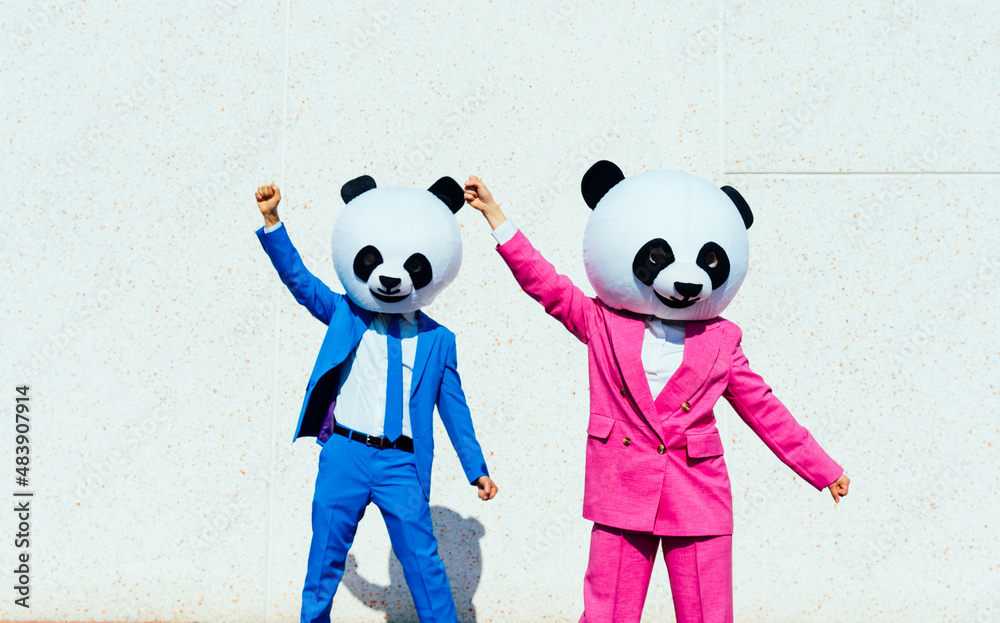Storytelling image of a group of friends wearing giant panda head. Man ...