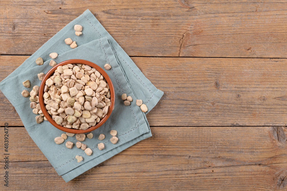 Cicerchia or indian pea on a bowl with napkin on natural wooden ...
