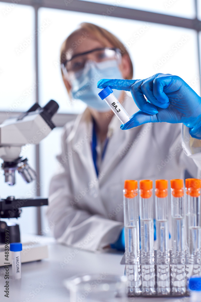 Female Lab Research Worker Wearing PPE Holding Test Tube Labelled BA.2 ...