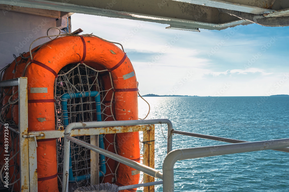 Orange inflatable lifeboats on ferry deck for emergencies and maritime ...