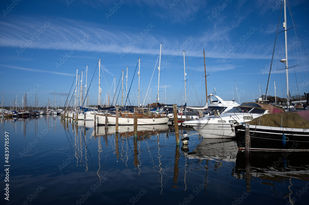 Yachts and Boat reflections in the water in Birdham Pool Marina which ...