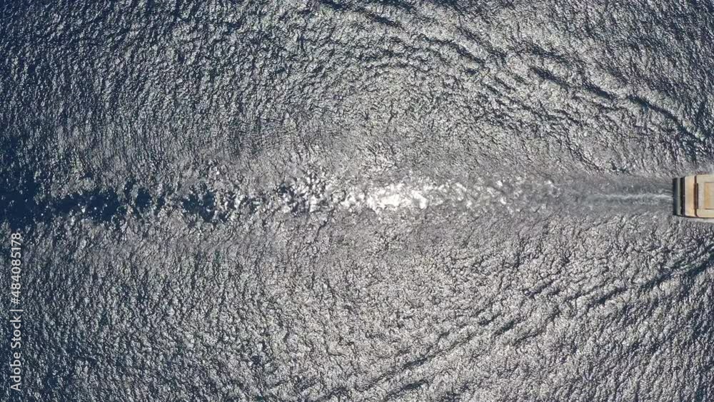 Ship cruising open water. Aerial top view of smart cargo ship carrying ...
