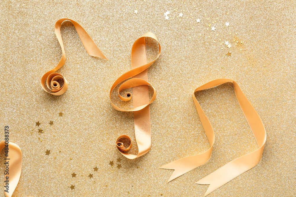 Music notes made of golden ribbons on shiny color background Stock ...