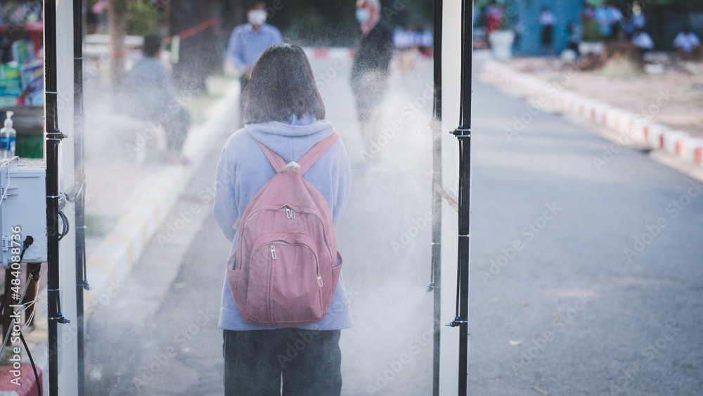 Students walk past alcohol sprayers to prevent Covid-19 in schools ...