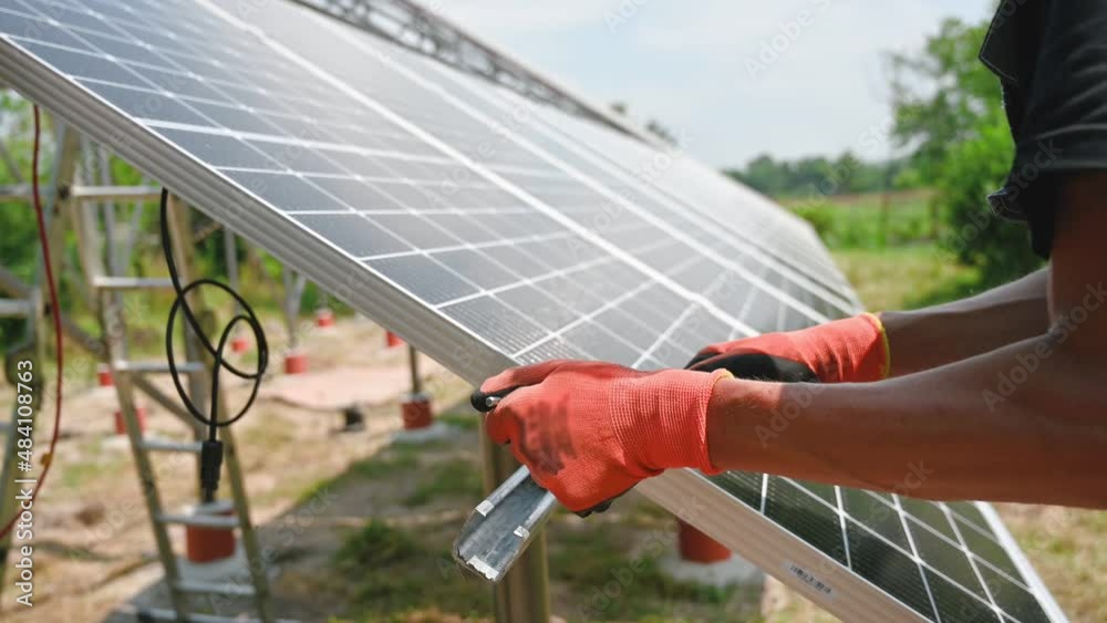 Close up view of worker mounting photovoltaic solar panel system ...