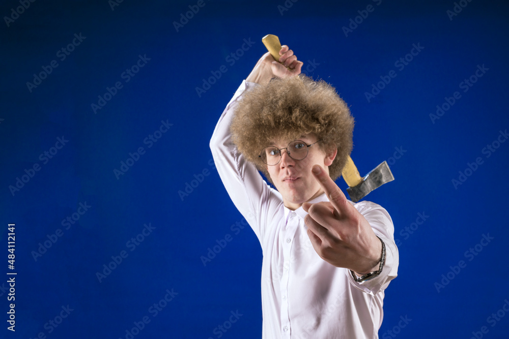 Psychopath. Maniac. Curly-haired man in a white shirt with an ax in his ...