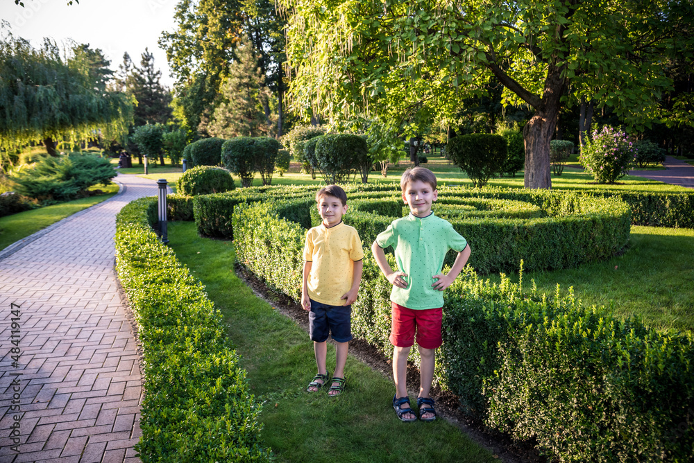 Two siblings playing at beautiful green park together. Happy family of ...