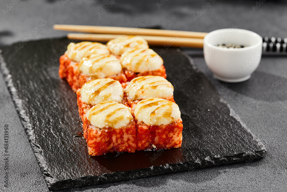 Baked Maki sushi on dark slate. Hot california maki with cheese. Sushi ...