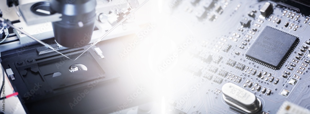 Soldering microprocessors under microscope. Manufacturing of ...