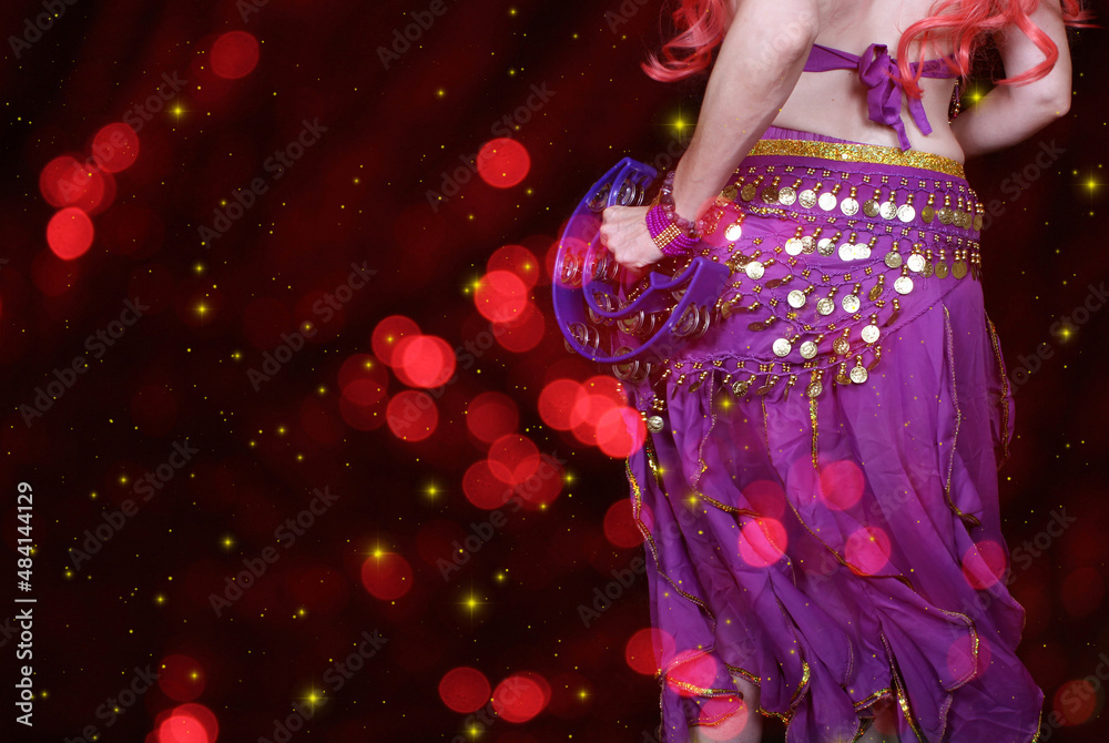 Belly Dancer wearing purple dance costume close up with bokeh Stock ...