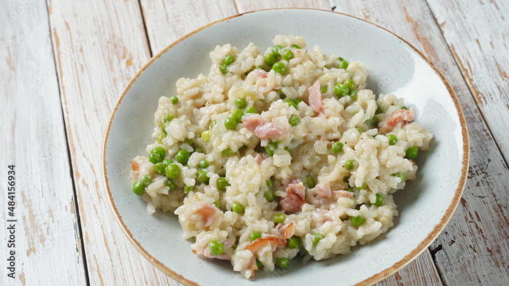 Classic italian risotto with peas, cheese parmesan, prosciutto. Risi e ...