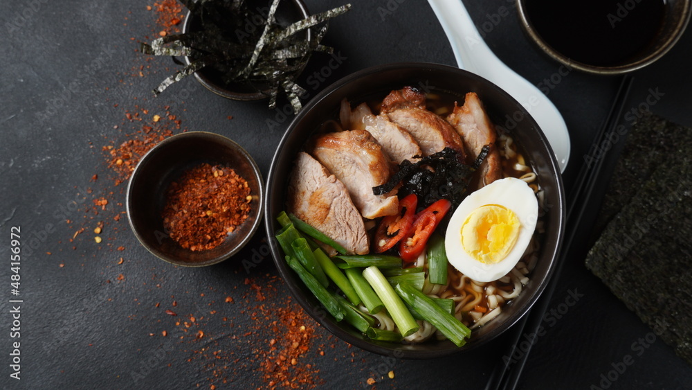 Ramen soup with hard boiled egg, vegetables, pork, soy sauce. Japanese ...