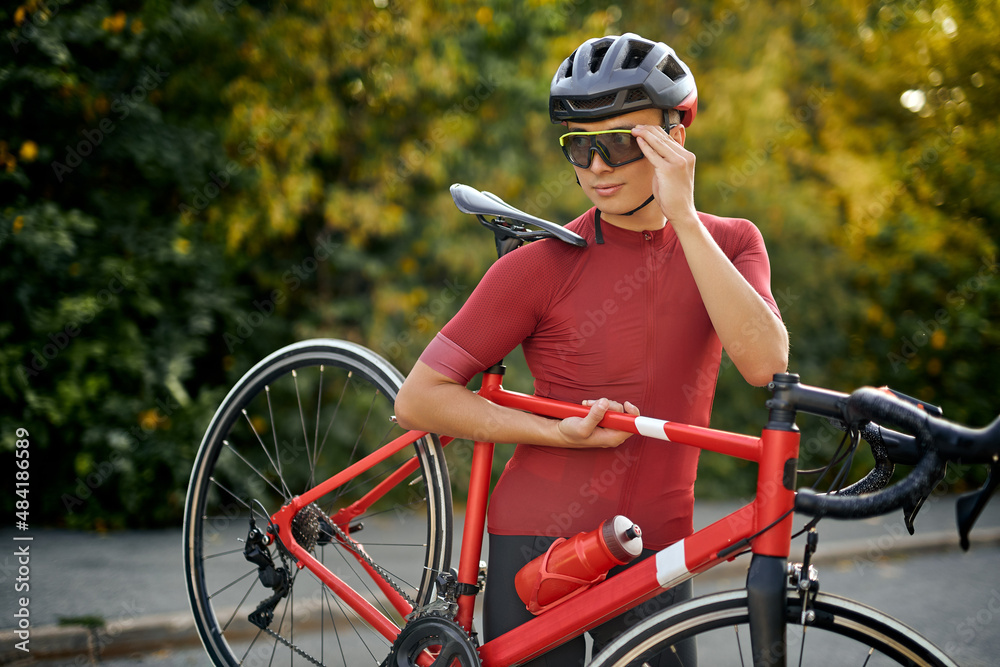 Handsome man biker in cycling clothing and protective helmet after ...