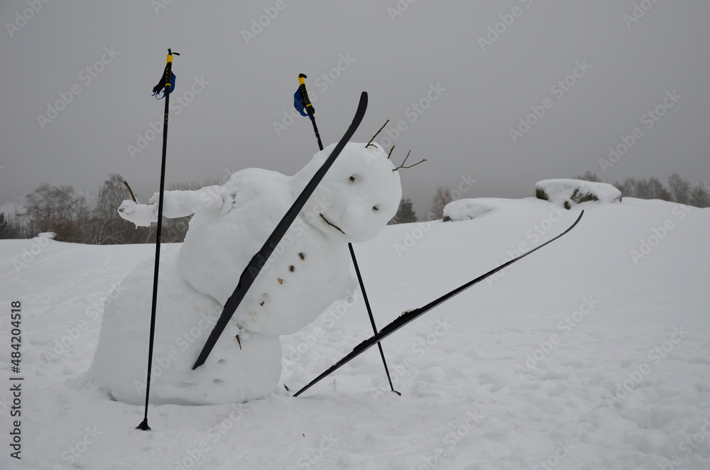 The big snowman has a tilted body that looks like he's falling. has ski ...