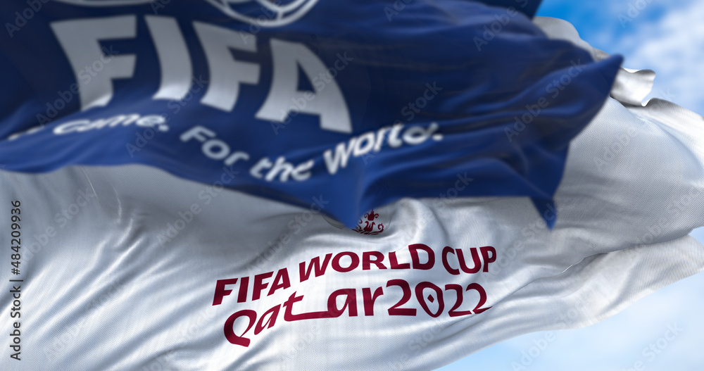 Flags with FIFA and Qatar 2022 World Cup logo waving in the wind Stock ...