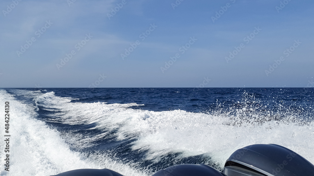 Sea wake trail behind a speed boat with waves, foam, bubbles on the ...