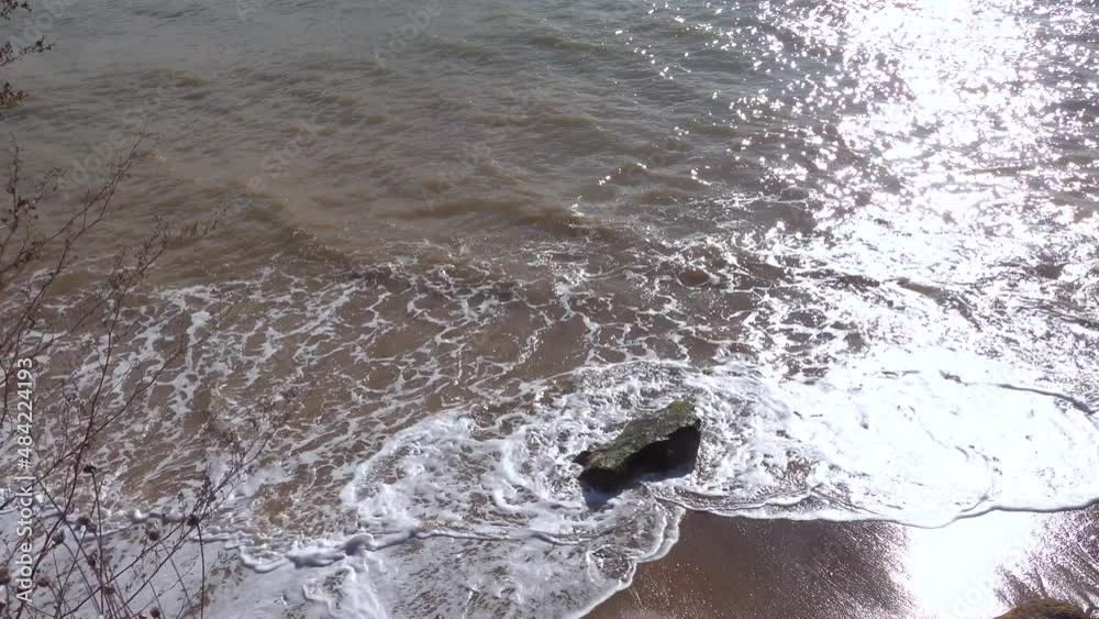Seascape, waves from muddy salty water on the beach in the Black Sea ...