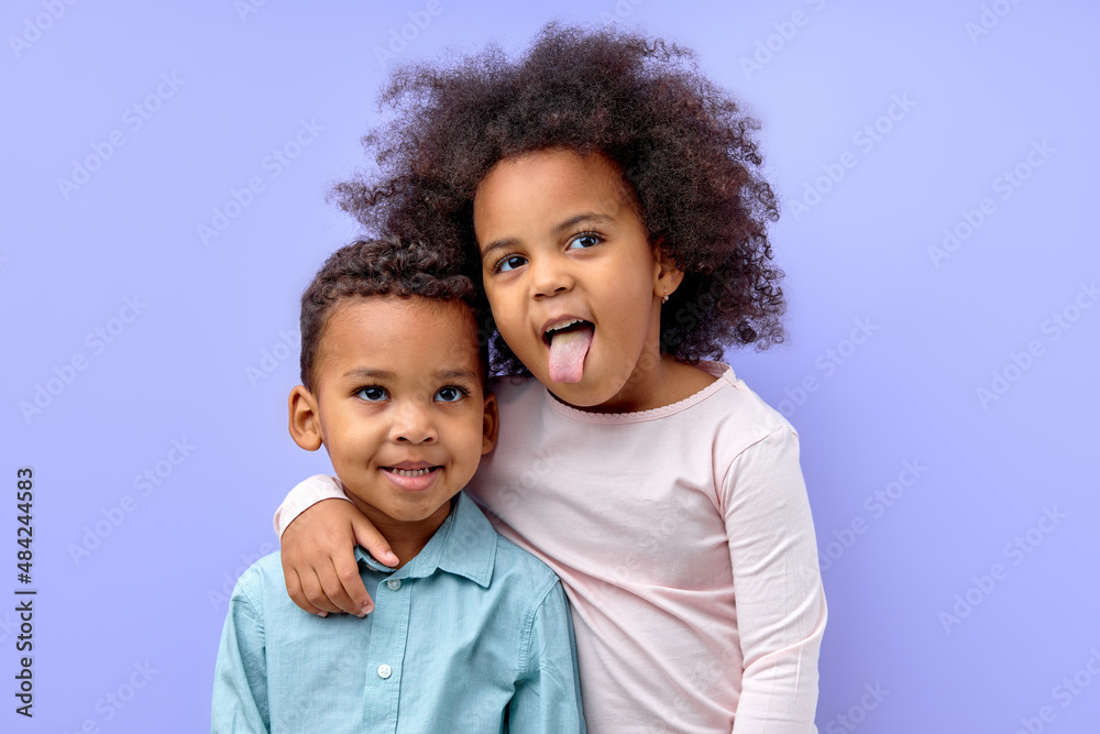 cheerful black children posing at camera and cheerfully smiling over ...