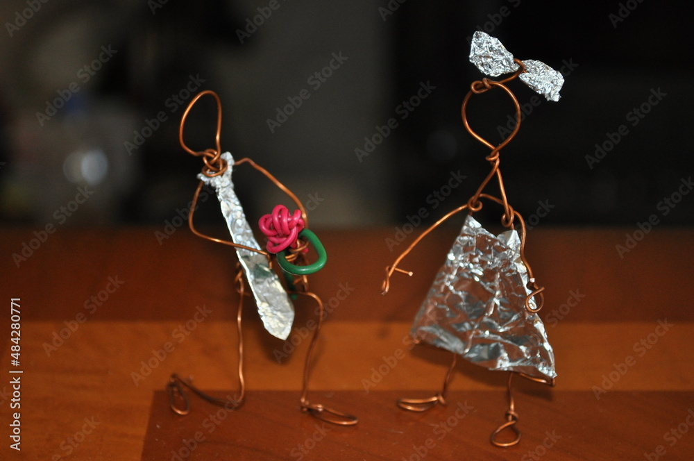 Handcrafted wire man giving flowers to wire woman. Kids crafts made ...
