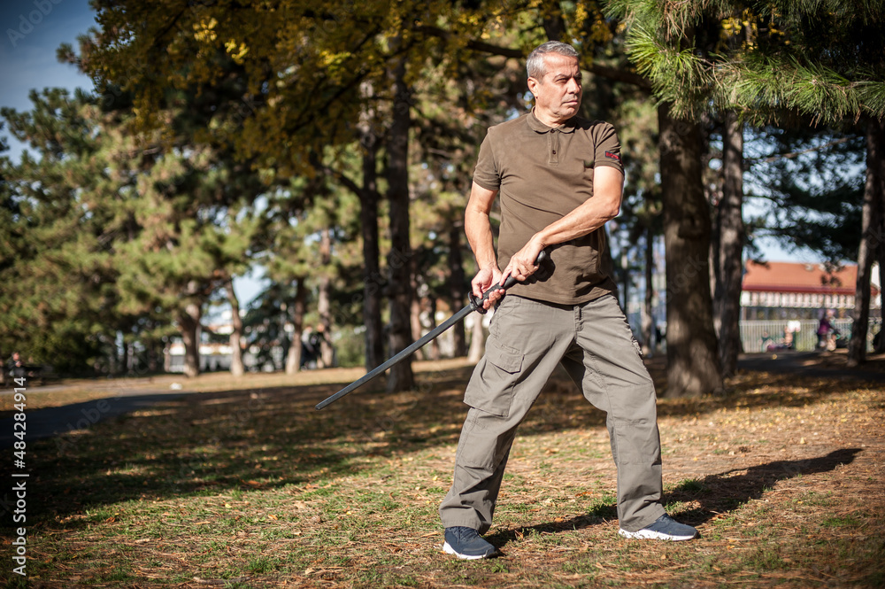Instructor demonstrates katana sword fighting techniques and training ...