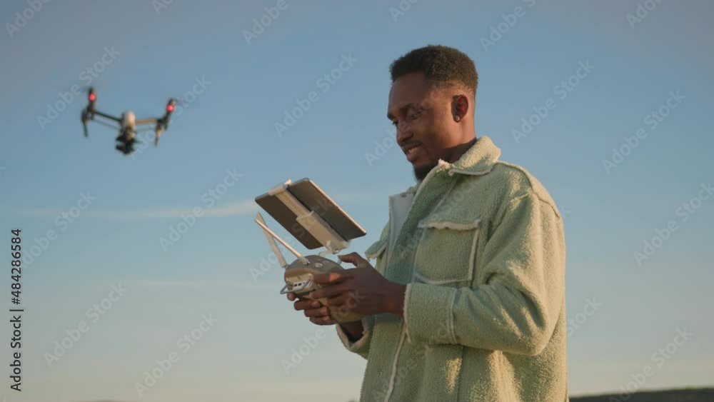 African american harvest expert with tablet controller flying ...