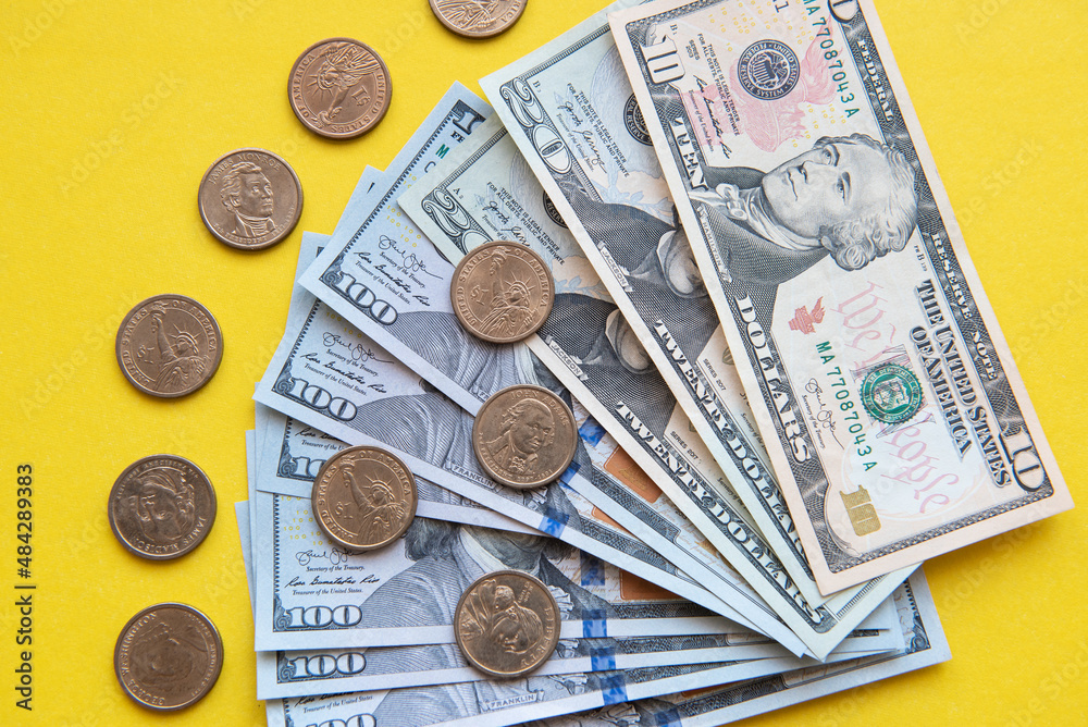 US dollar bills and coins. different denomination dollar bills and ...