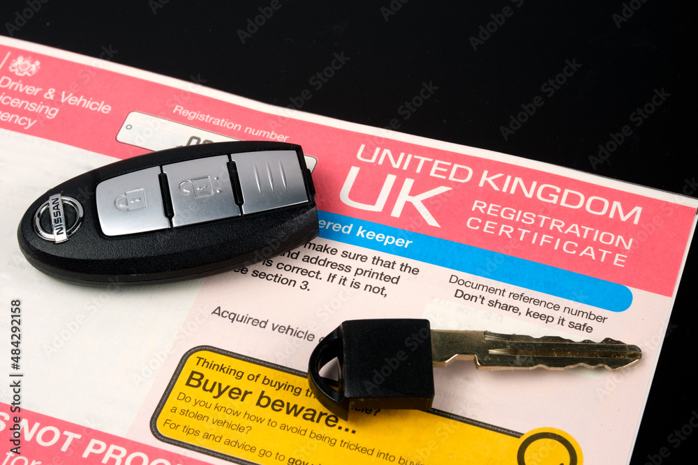 Genuine UK registration certificate for a purchased car and car key on ...