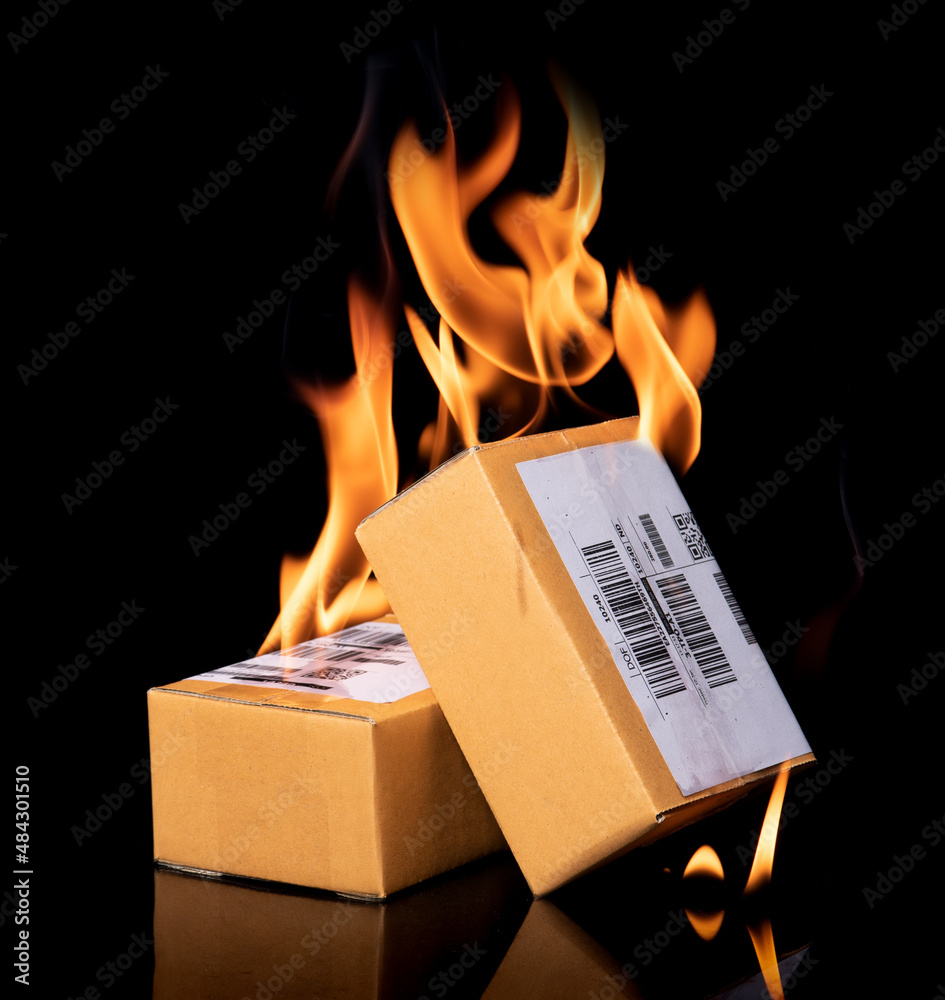 damaged cardboard parcel on black background,Burning cardboard box ...