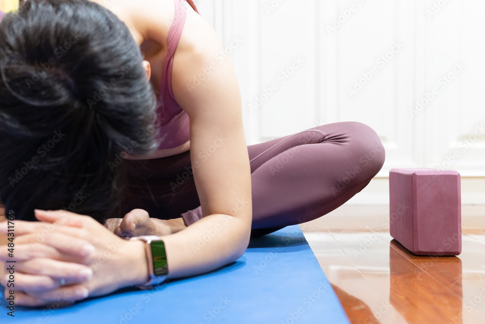 Healthy Asian woman in sportswear doing seated diamond yoga pose to ...