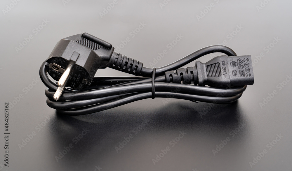 black power cable for PC, monitor, equipment on black background. a ...