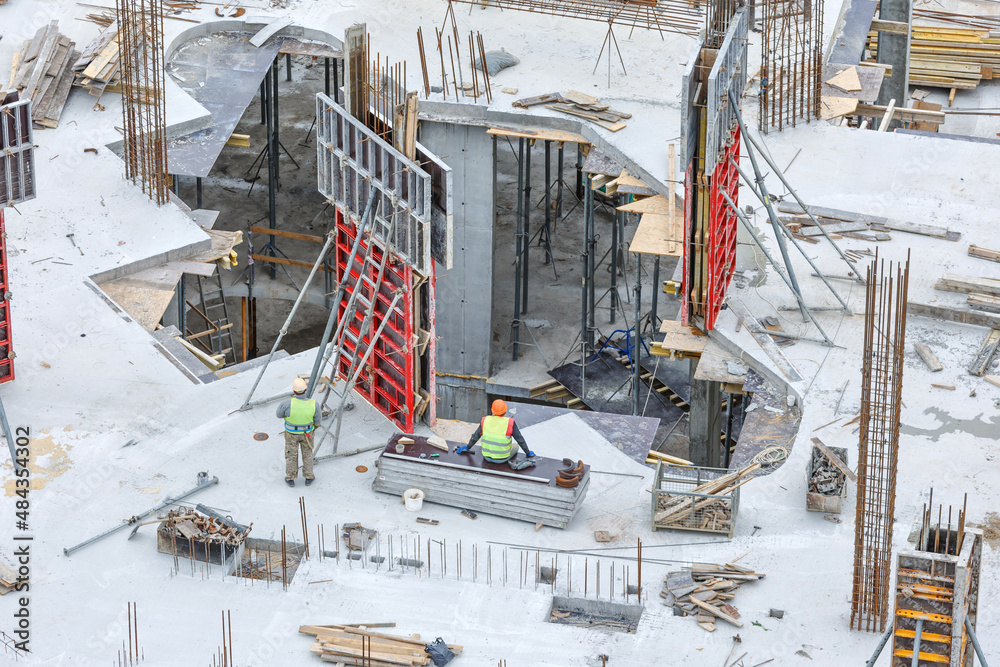 Building construction site work against blue sky.Hydraulic luffing jib ...