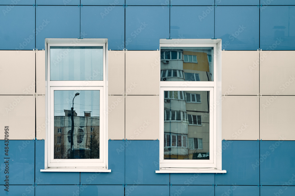 The wall of the building covered with decorative tiles, two plastic ...