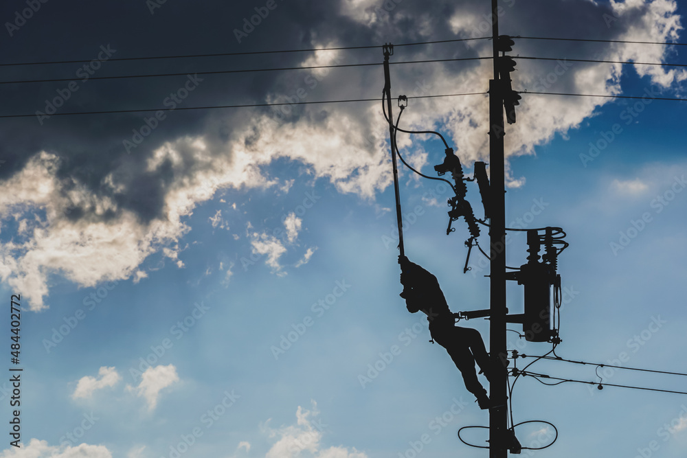 Poster The silhouette of power lineman replacing a transformer and ...