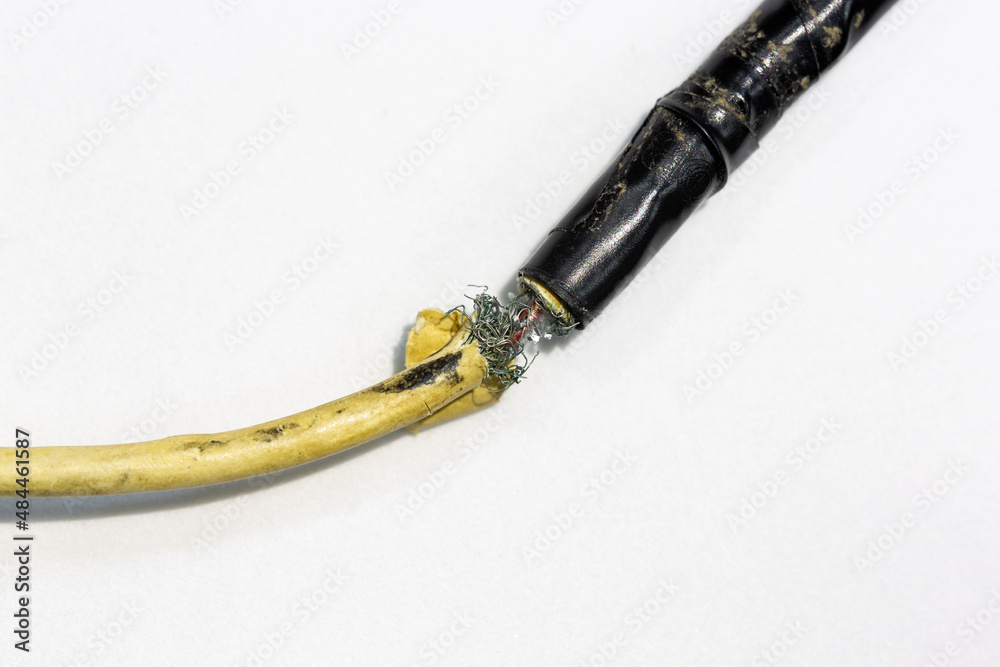 Damaged, broken part of USB charging cable. The wires stick out of the ...