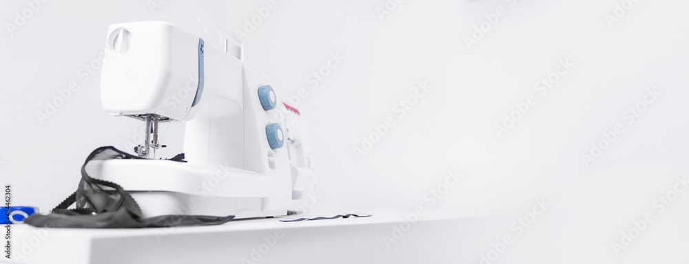 Banner Sewing machine on table workshop of tailor white background ...