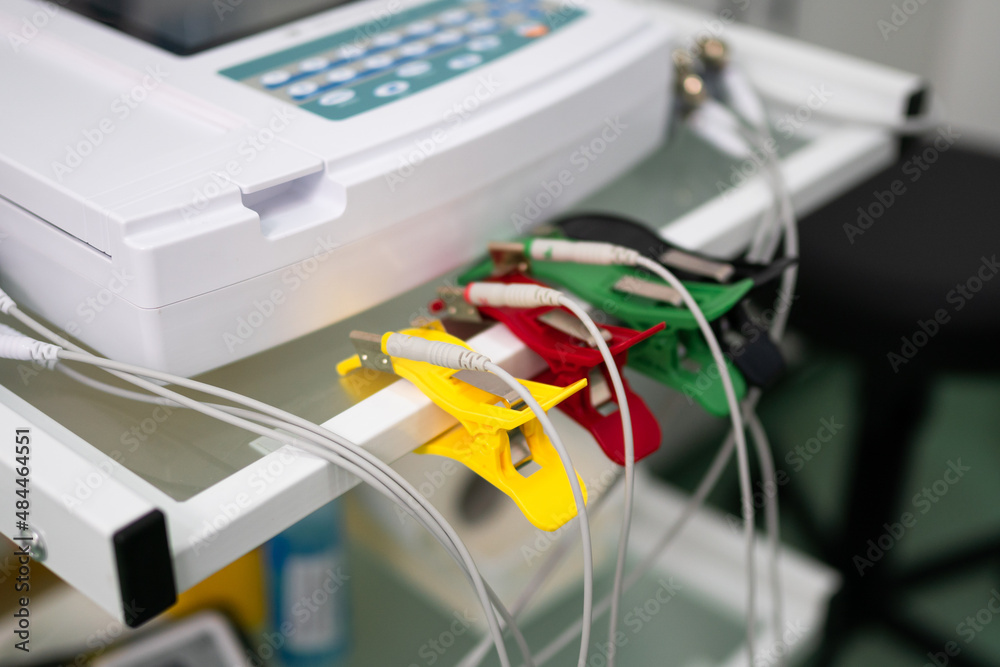 Cardiologist doctor performs electrocardiography procedure on man lying ...