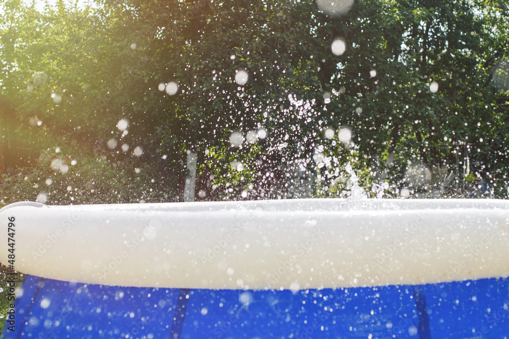 Splash of water in the swimming pool from kid jump. water splash ...