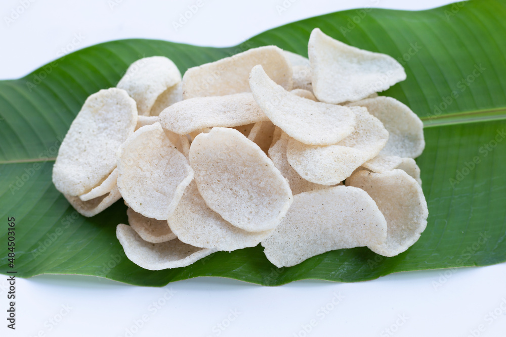 Prawn crackers on green leaf on white background. Shrimp crispy rice ...